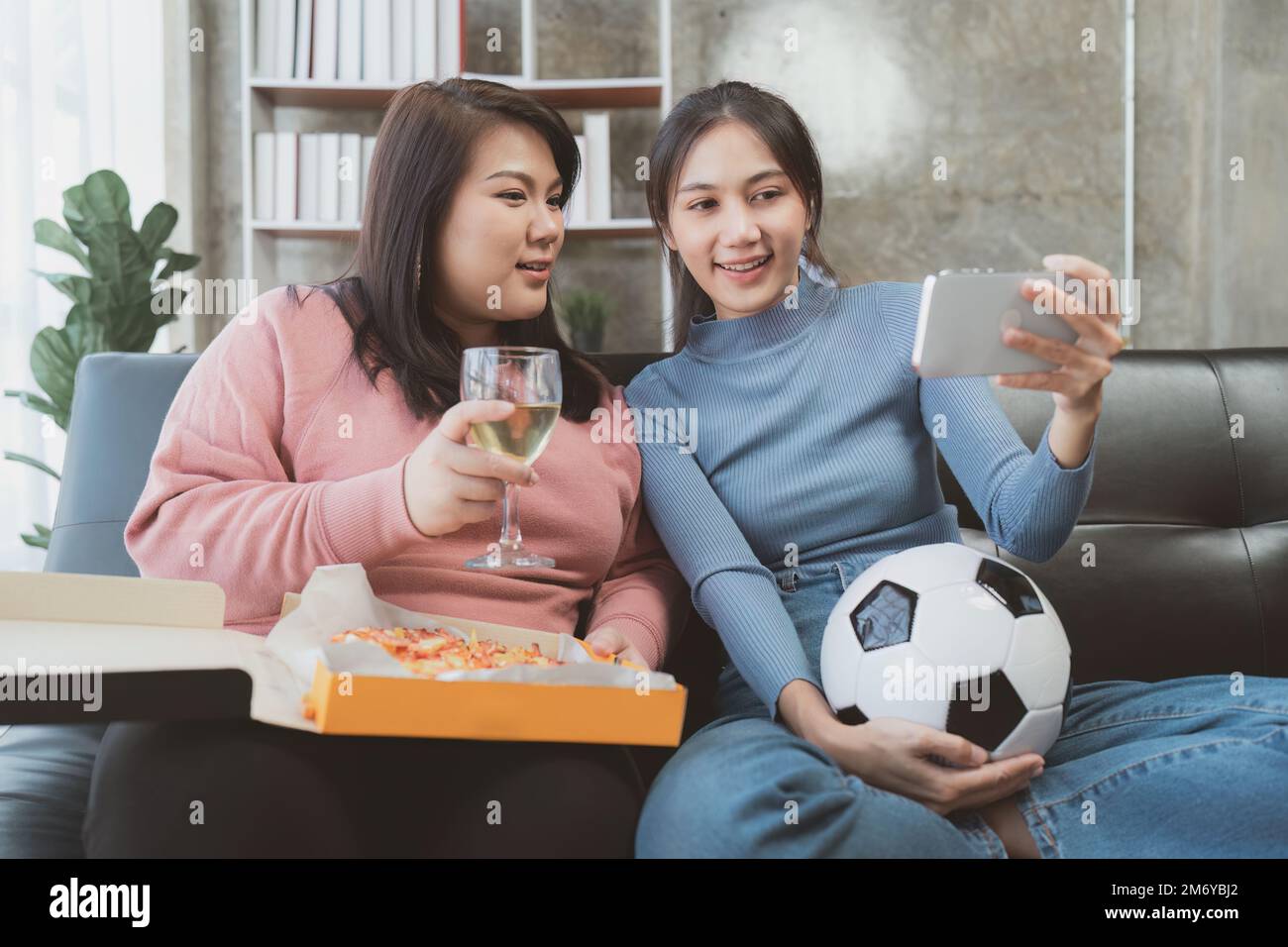 Excited friends having fun by watching football or soccer match and ...