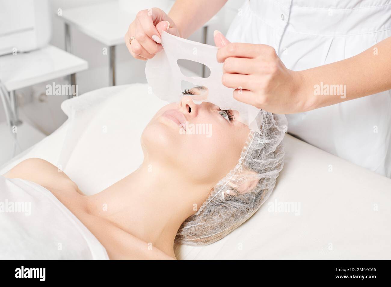 Beautician removing sheet mask on woman face for rehydrate face skin ...