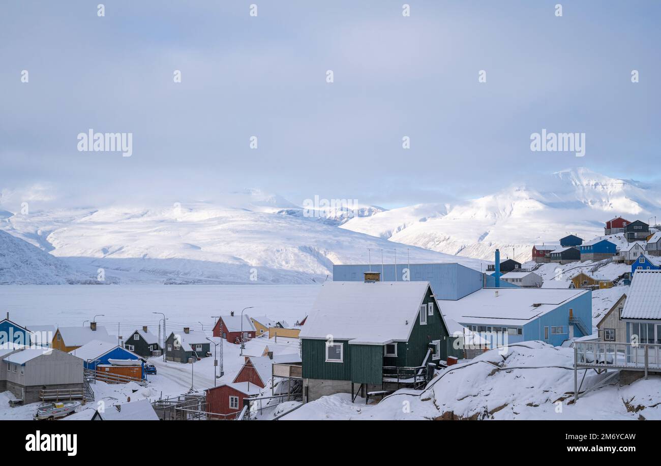 Colourful houses clinging to the side of the mountain on Uummannaq ...