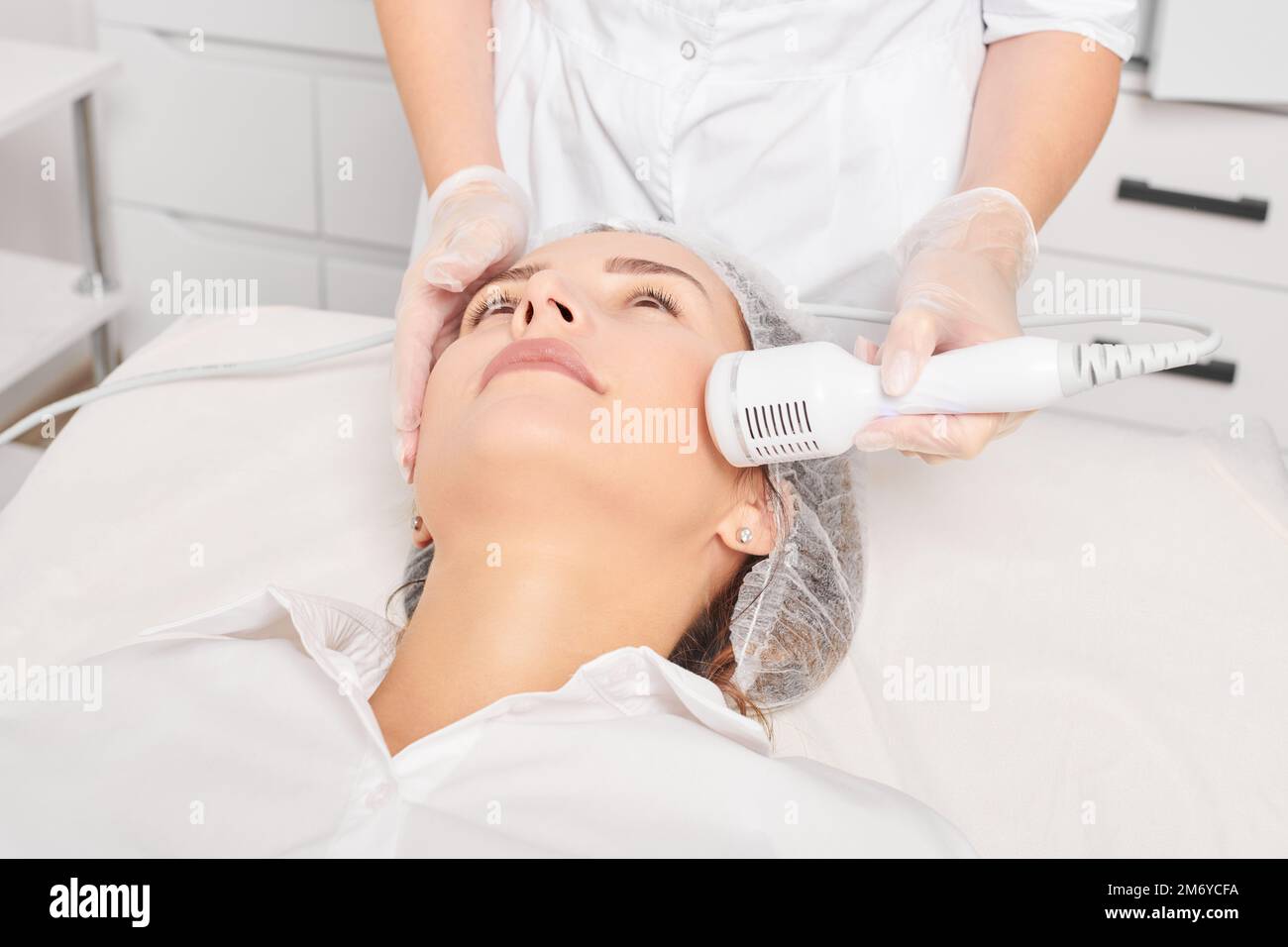 Cosmetologist makes cryotherapy for rejuvenation woman face, anti aging ...