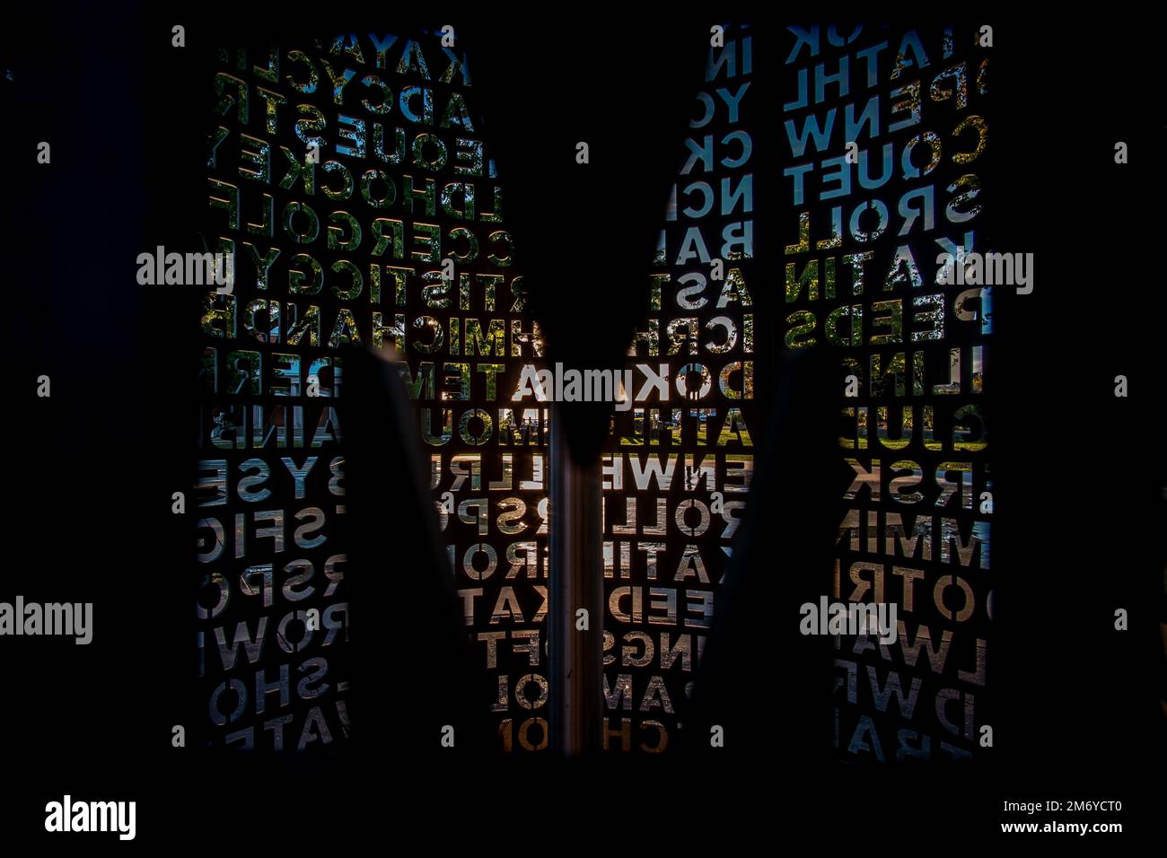 A closeup shot of the letter M inside the sculpture by a fountain Stock ...