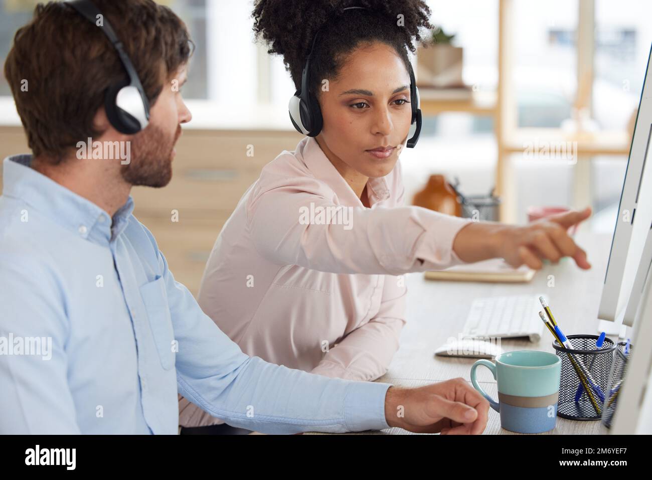 Man helping coworker hi-res stock photography and images - Alamy