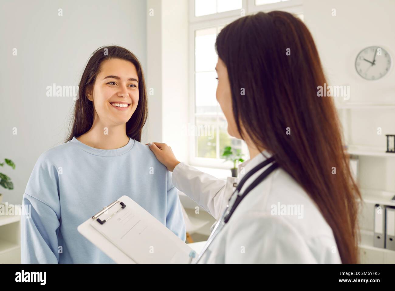 Caucasian woman smiling, feeling joy from support of doctor hospital ...
