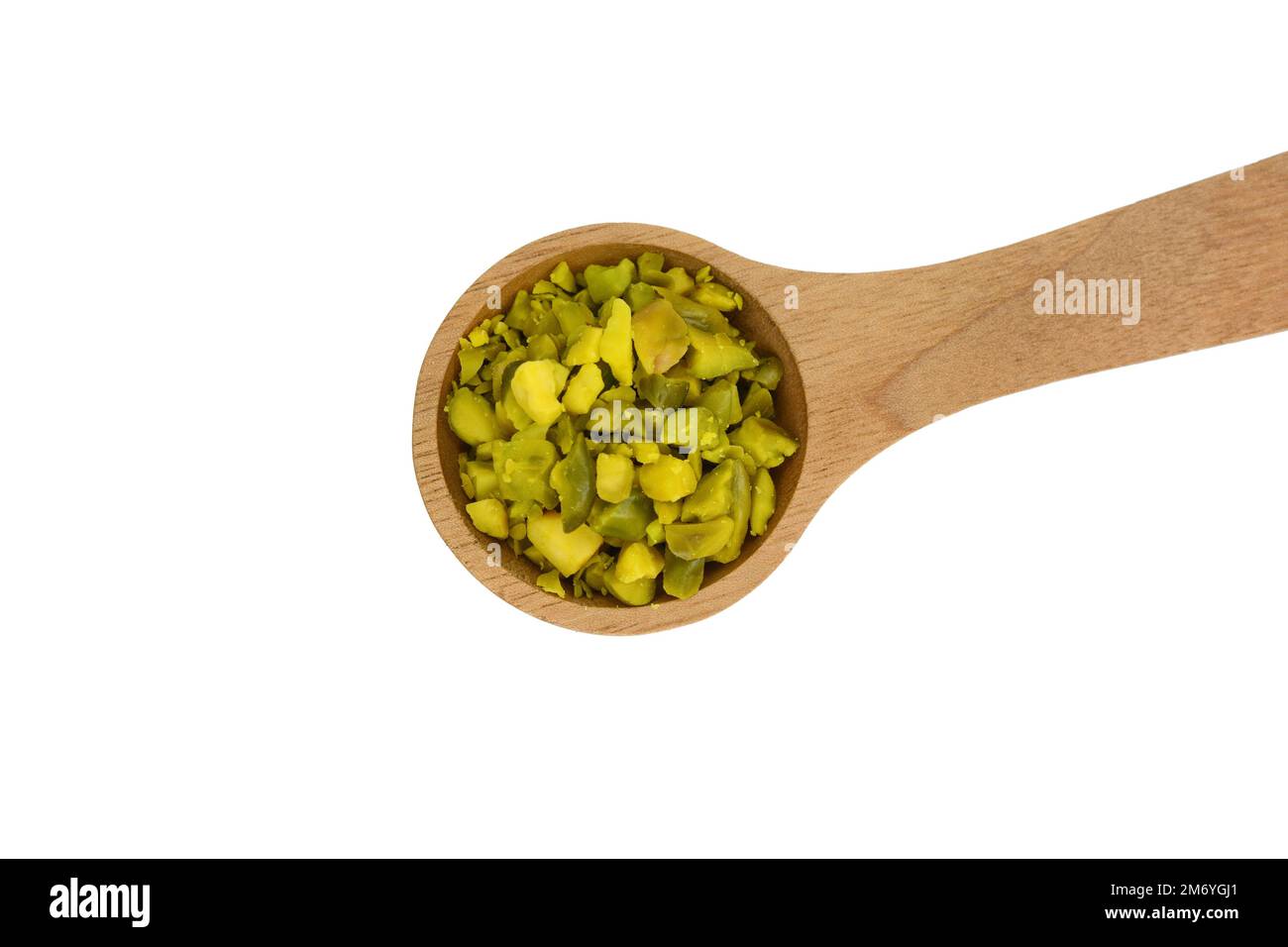 Chopped Pistachios in a wooden spoon isolated on white Background Stock ...