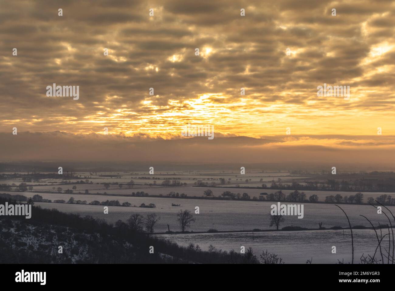Winter snowy landscape with spectacular golden sunset, Balassagyarmat ...