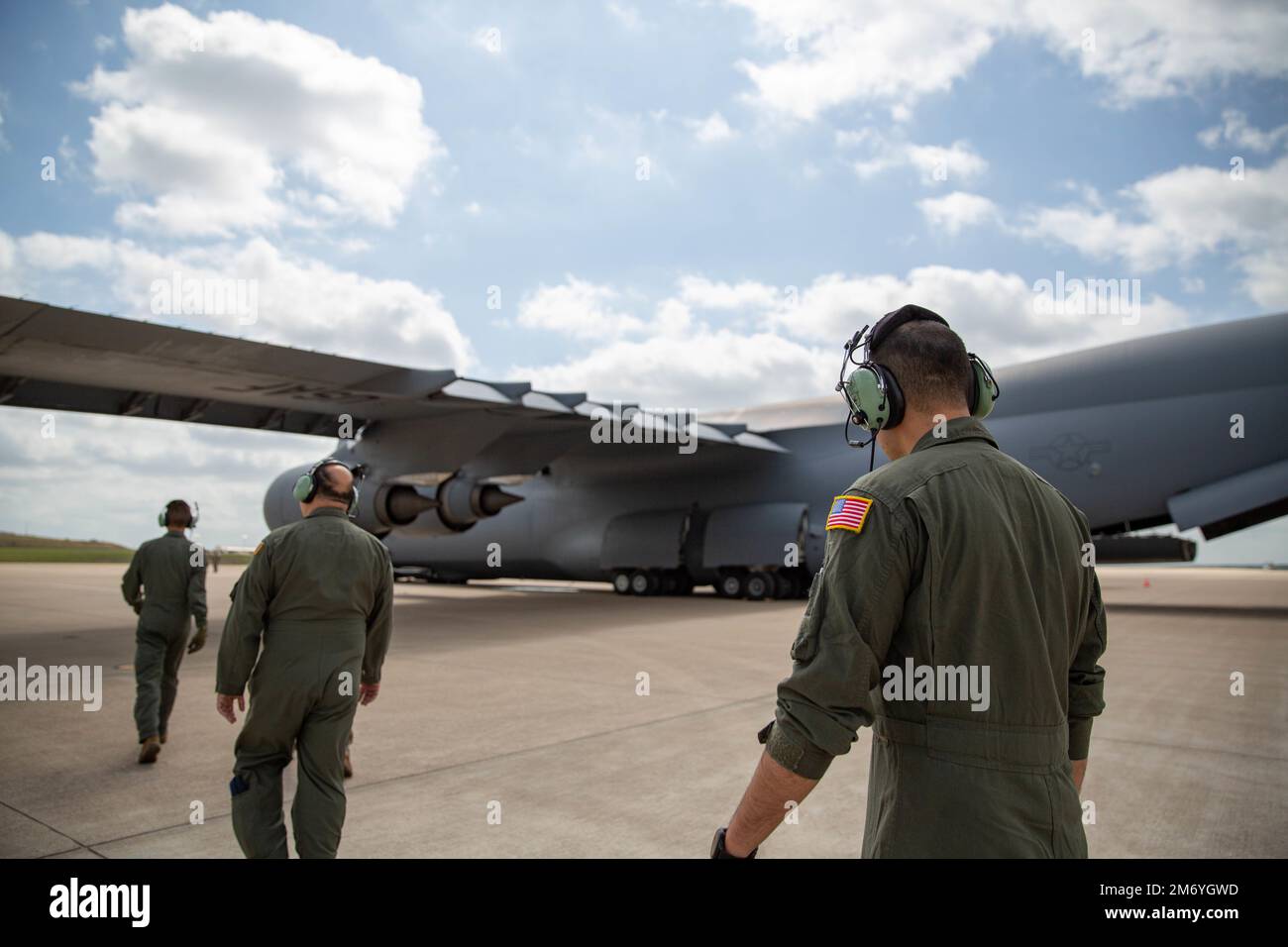 U.S. Air Force Aircrew from the 68th Airlift Squadron approach a C-5M ...