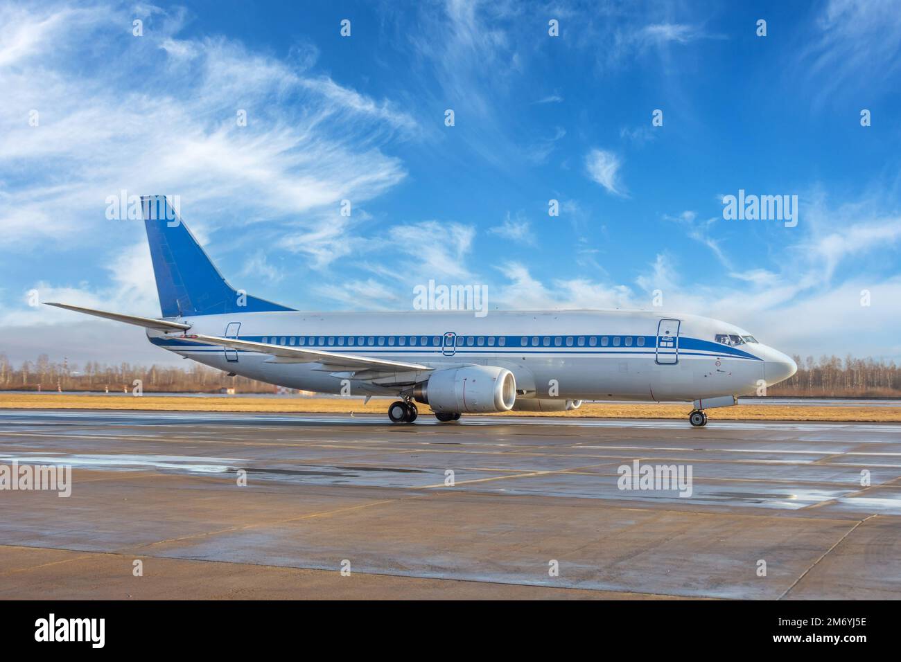 Passenger plane jet taxi on the taxiway at the airport, side view Stock ...