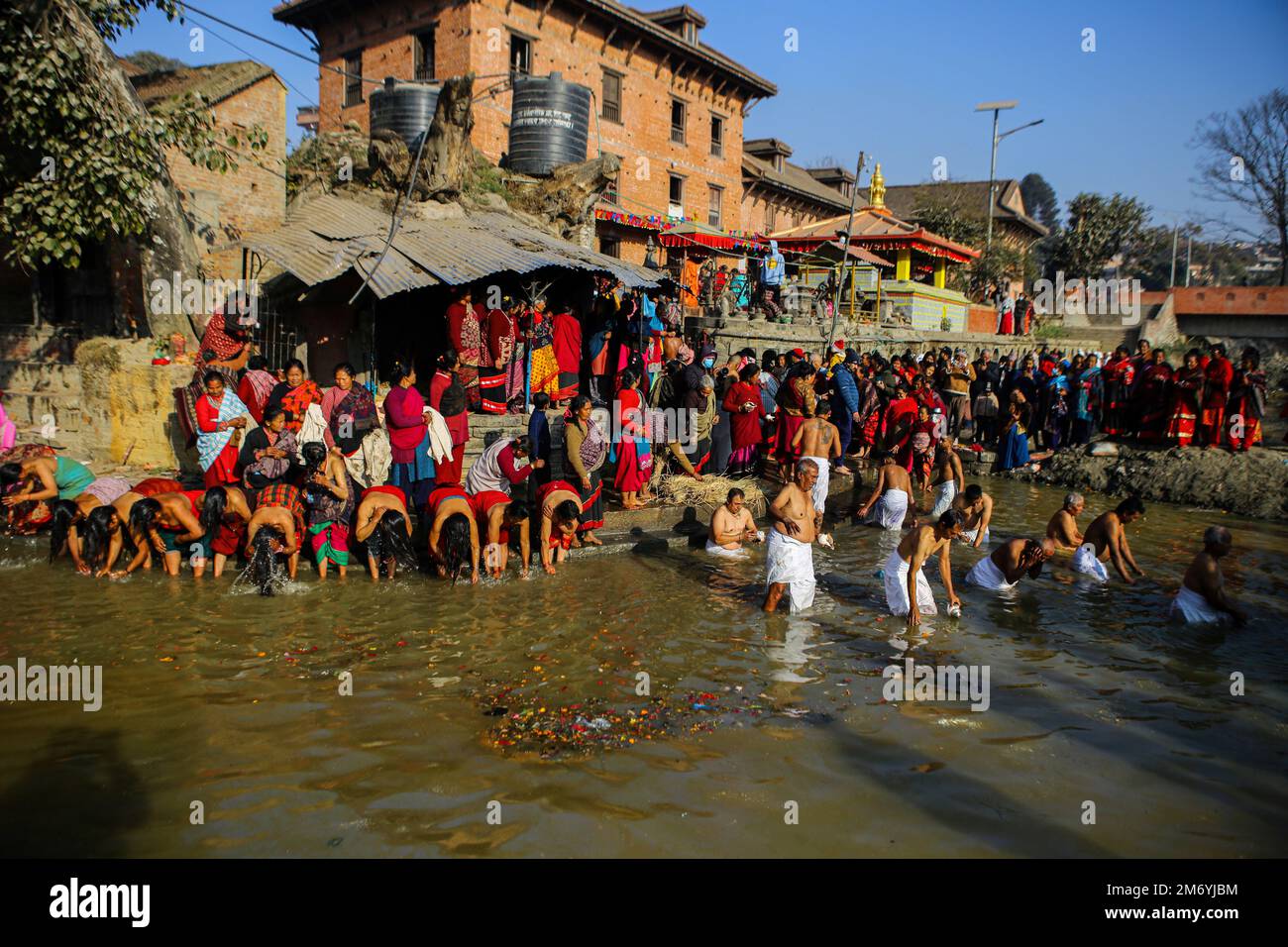 Bhaktapur, Nepal. 06th Jan, 2023. Hindu devotees stand at the bank of ...
