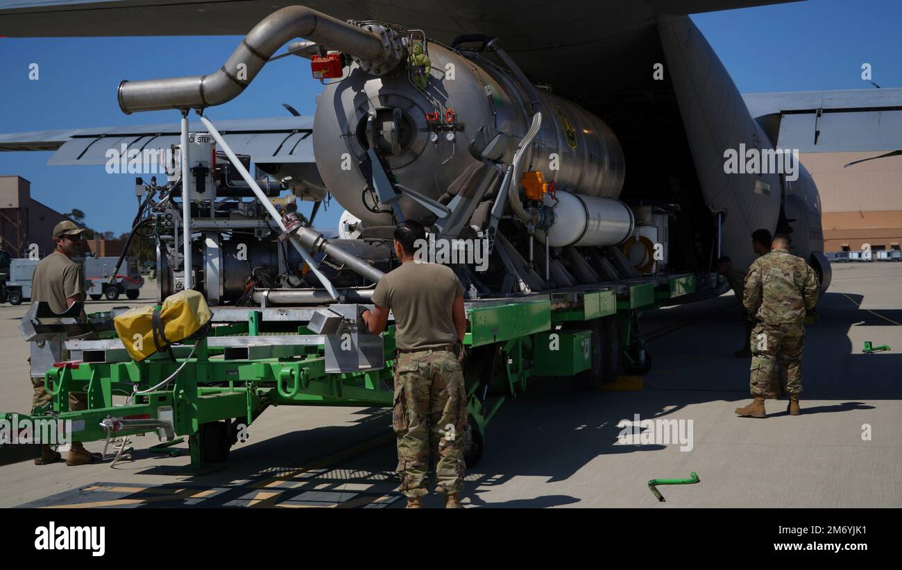U.S. Air Force personnel from the 146th Airlift Wing load the U.S ...