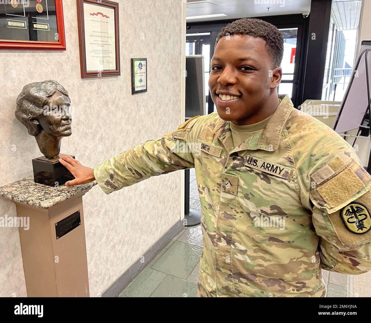 BACH Soldier Pfc. Tyrion Smith, touches a likeness of Blanchfield Army ...