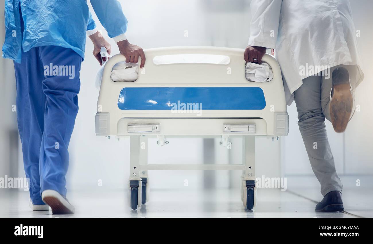 Hospital emergency, bed and legs of doctors, nurse or surgeon running ...