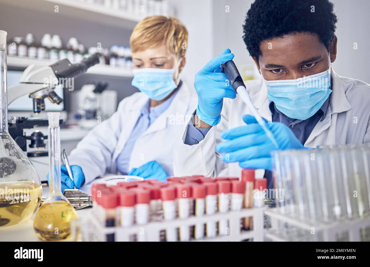 Science, innovation and covid, teamwork in laboratory with test tube ...