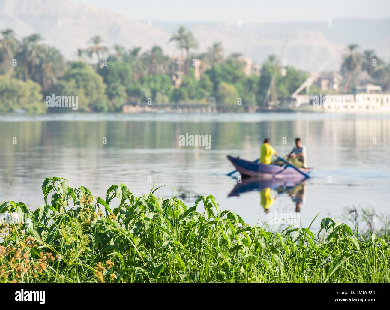Traditional egyptian bedouin fisherman in rowing boat on river Nile ...