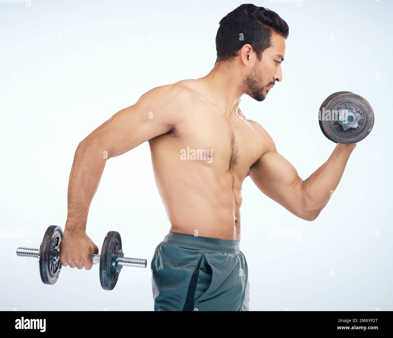 Fitness, studio or strong man training with dumbbells for powerful arms ...