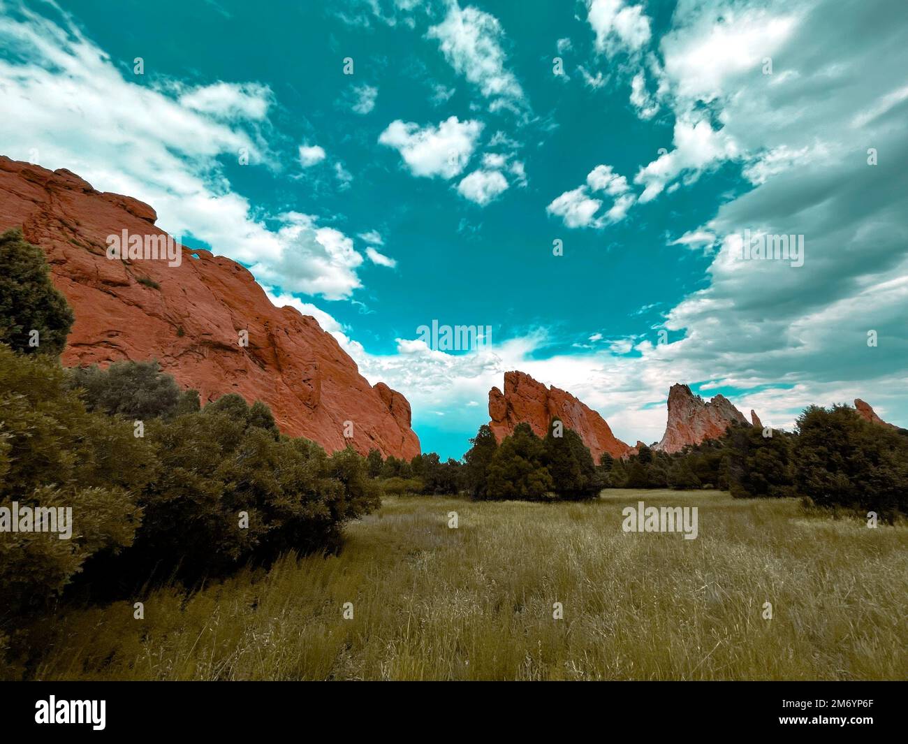 An aerial view of red cliffs surrounded by dense trees Stock Photo - Alamy