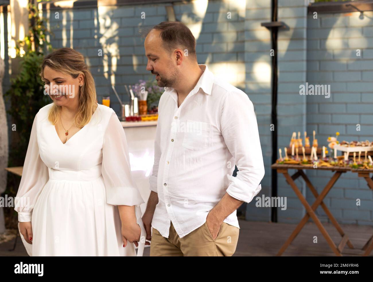 Middle age wedding couple enjoying romantic moments outside on a summer ...