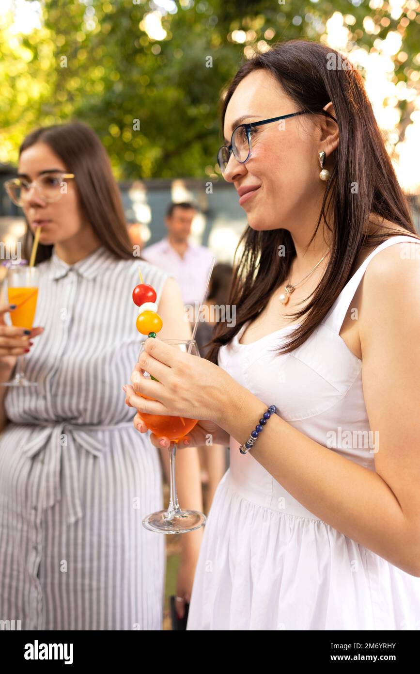 Happy female friends spending time together, young woman drinking ...