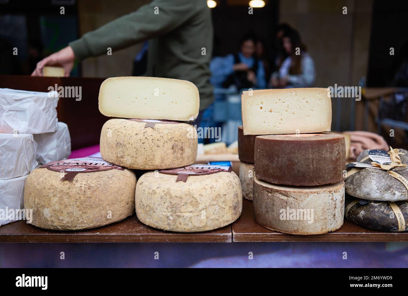 A pile of artisan cheese wheels in a traditional market Stock Photo - Alamy