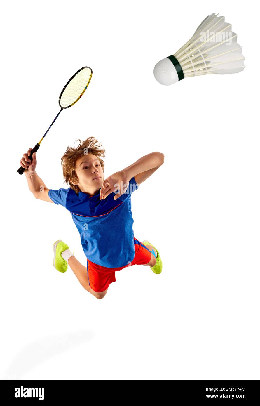 Top View. Motivated teen boy in uniform playing badminton, hitting ...