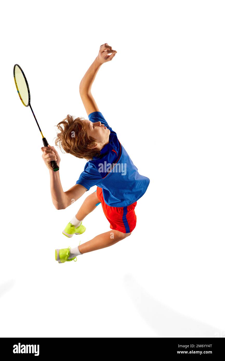 Top View. Active teen boy in uniform playing badminton, hitting ...
