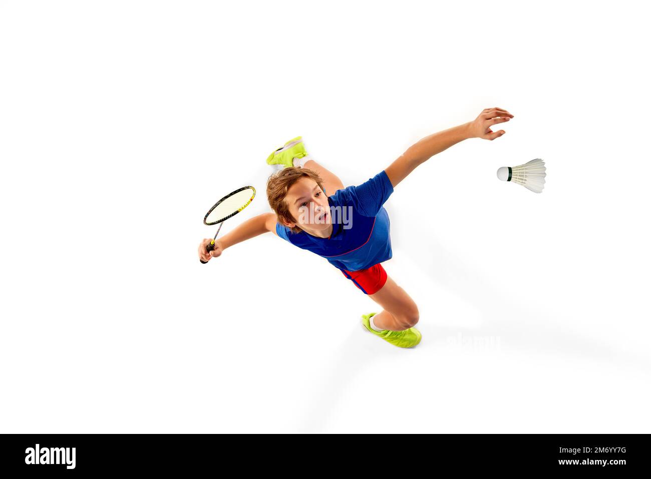 Top View. Concentrated teen boy in uniform playing badminton, hitting ...