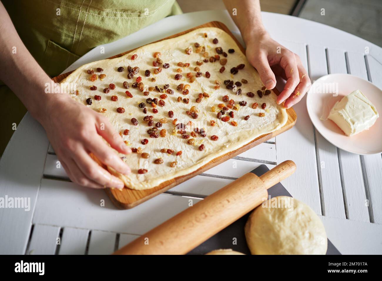 Easter pastry or cruffin preparation at home concept. Baker pours ...