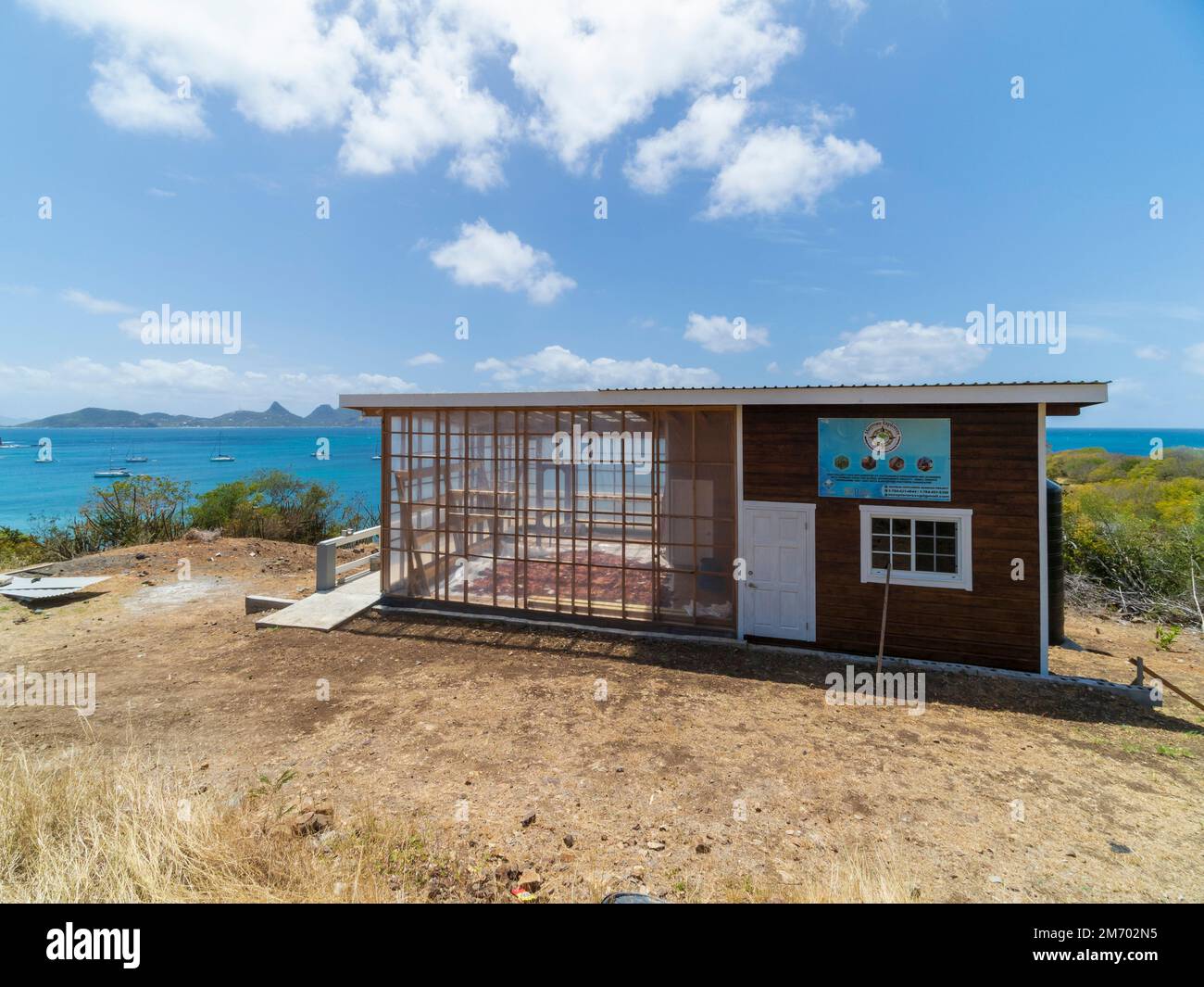 Mayreau, Grenadines, Caribbean island. Seaweed drying facility, turns ...