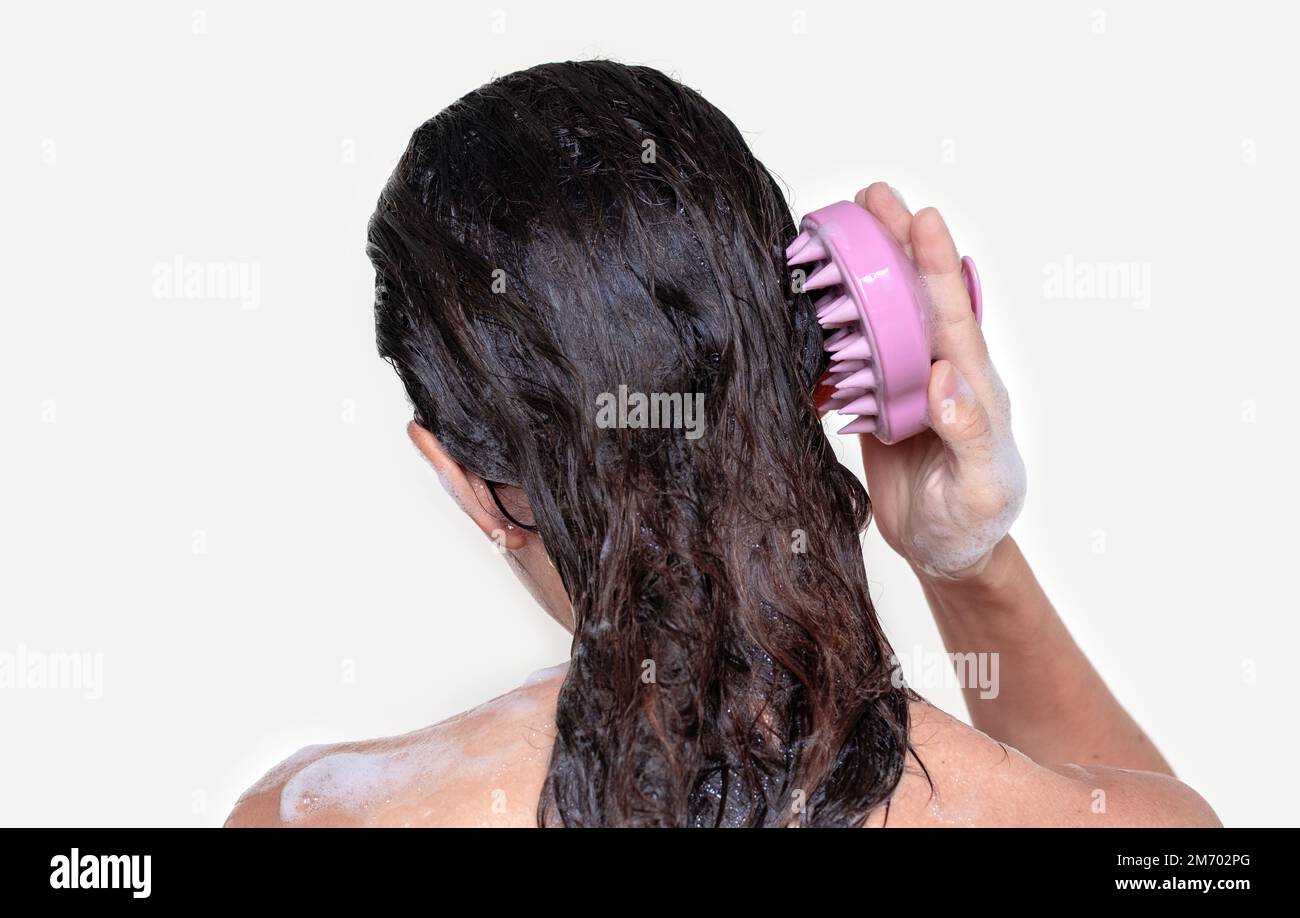 hair growth stimulating,scalp massage.woman use massager shampoo brush ...