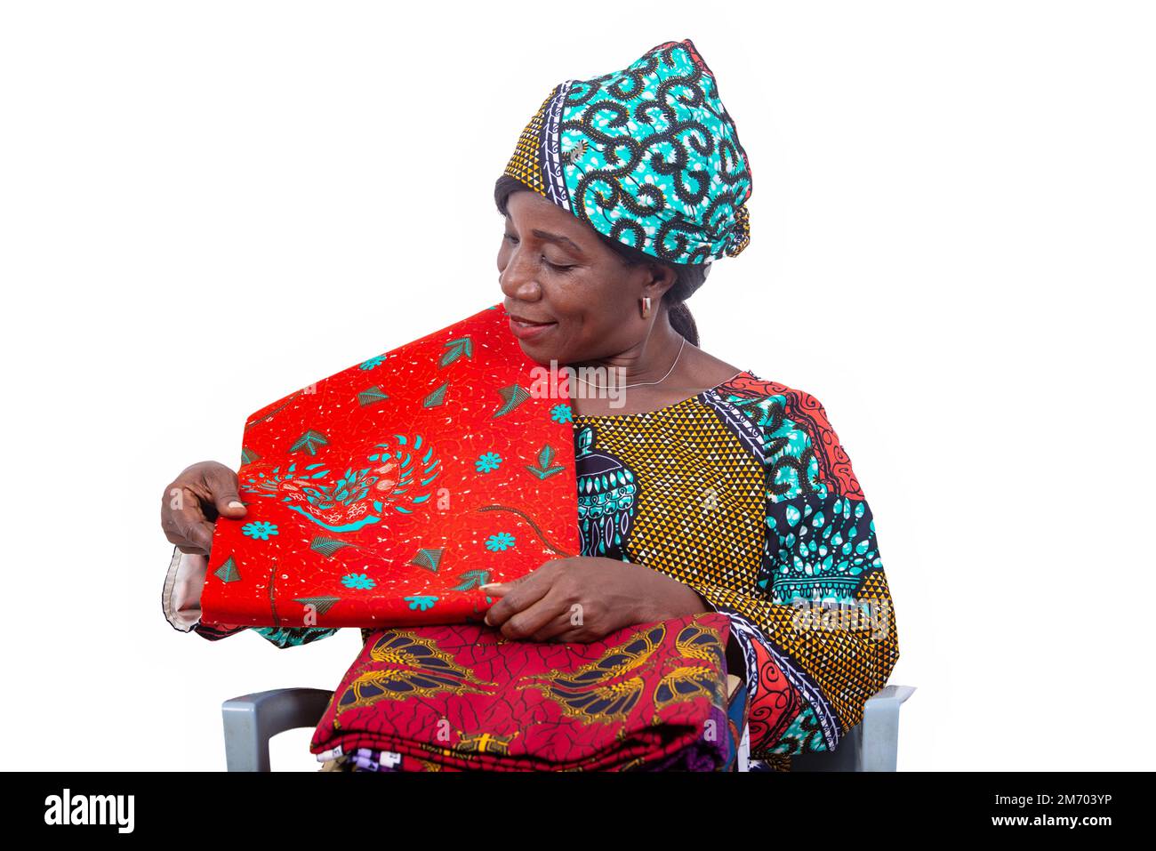 woman sitting on a chair with different traditional loincloths on her ...