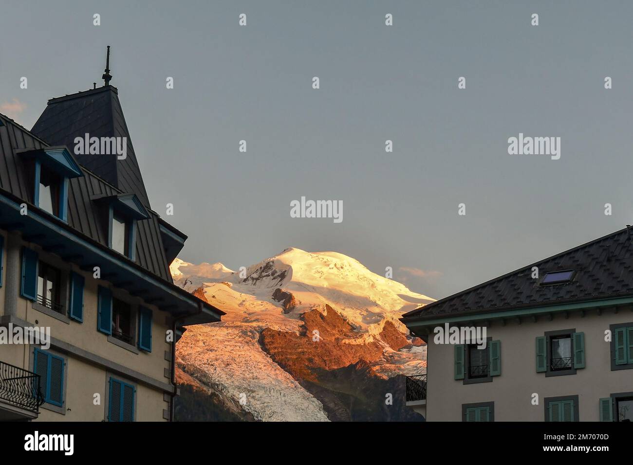 View of the top of Mont Blanc from the centre of Chamonix at sunset in ...