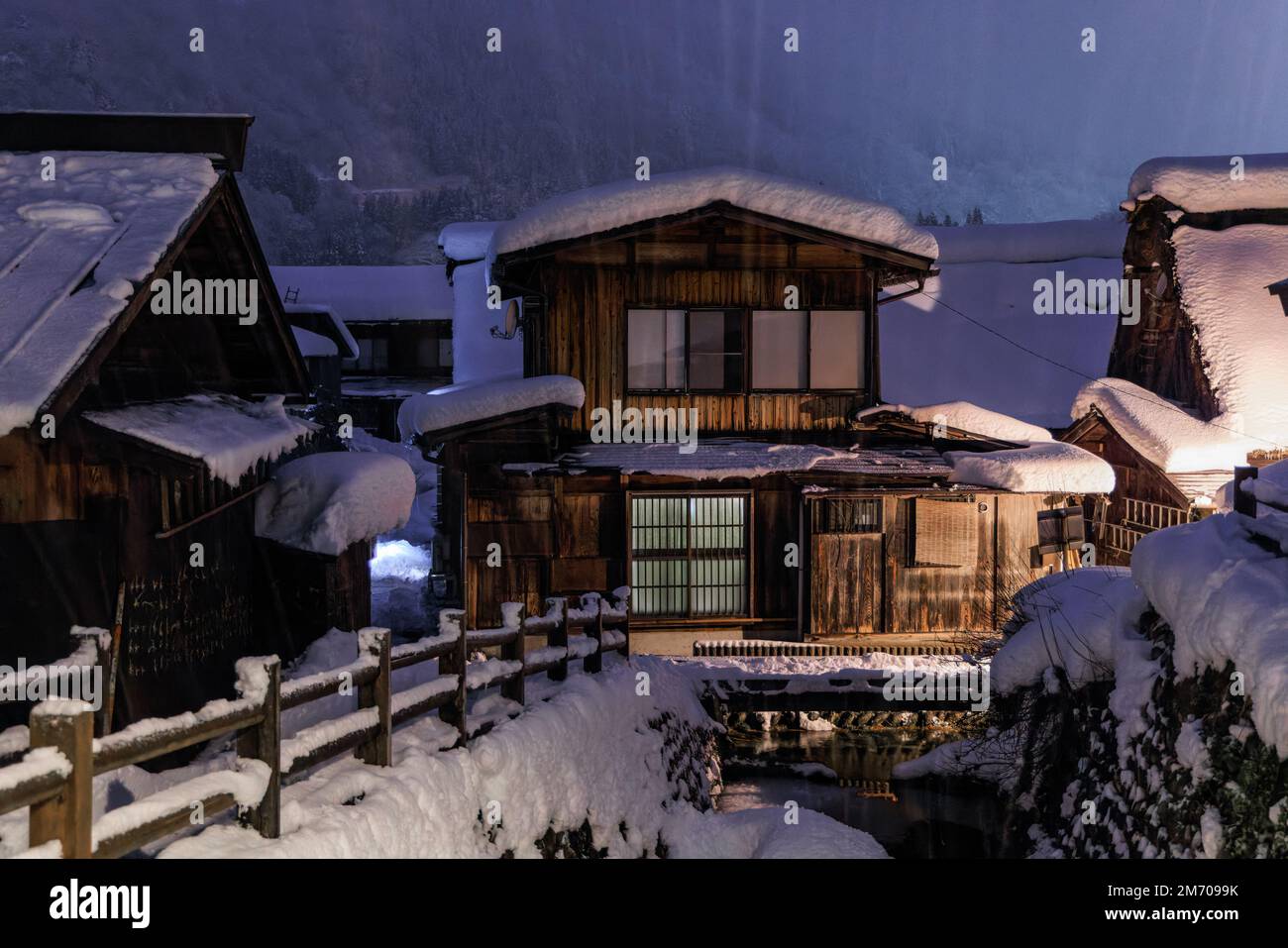 Heavy snow falls on traditional wooden homes in Japanese village at ...