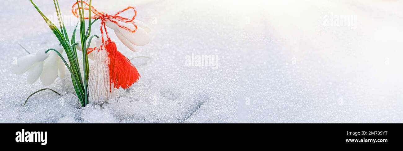 Martisor and Baba Marta. Symbols of spring. of rope on a snow ...
