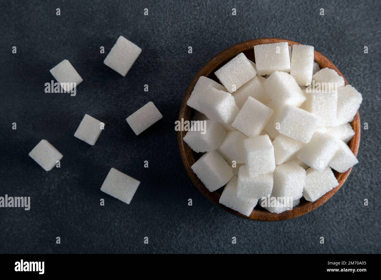Cube sugar and granulated sugar on dark background Stock Photo - Alamy