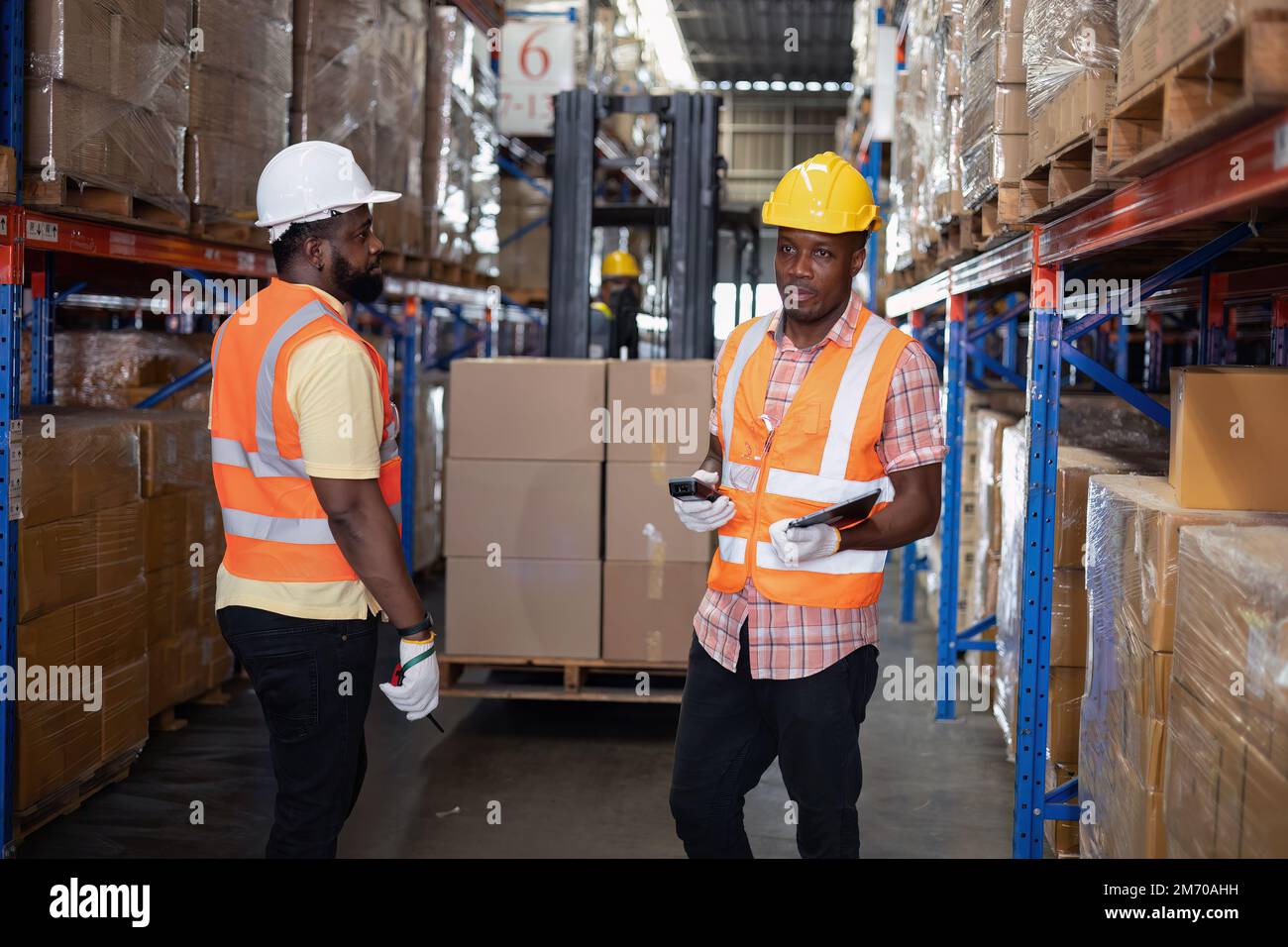 Worker in depot storage warehouse use tablet pc check scan barcode ...