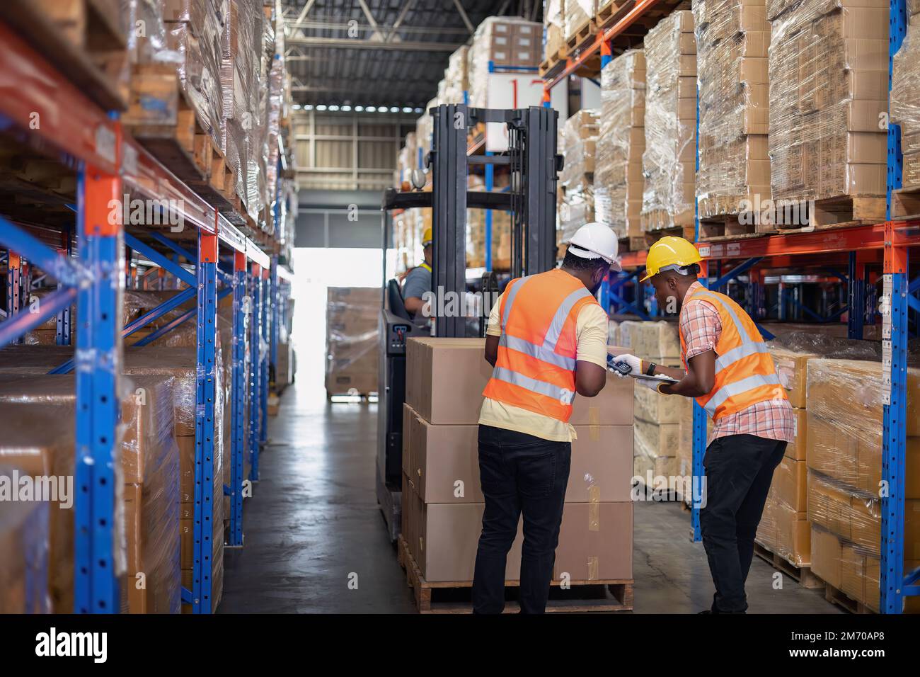 Worker in depot storage warehouse use tablet pc check scan barcode ...