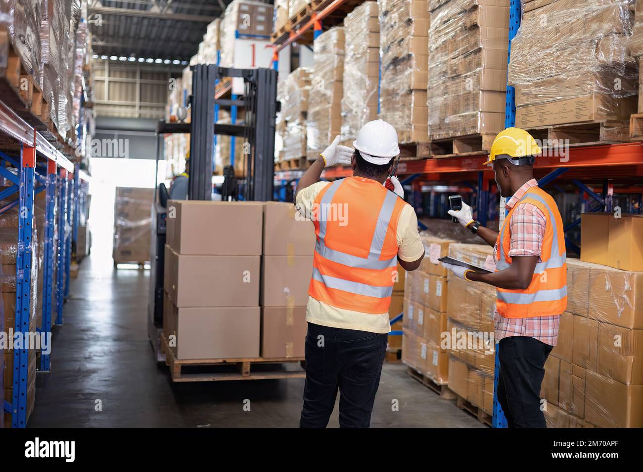 Worker in depot storage warehouse use tablet pc check scan barcode ...