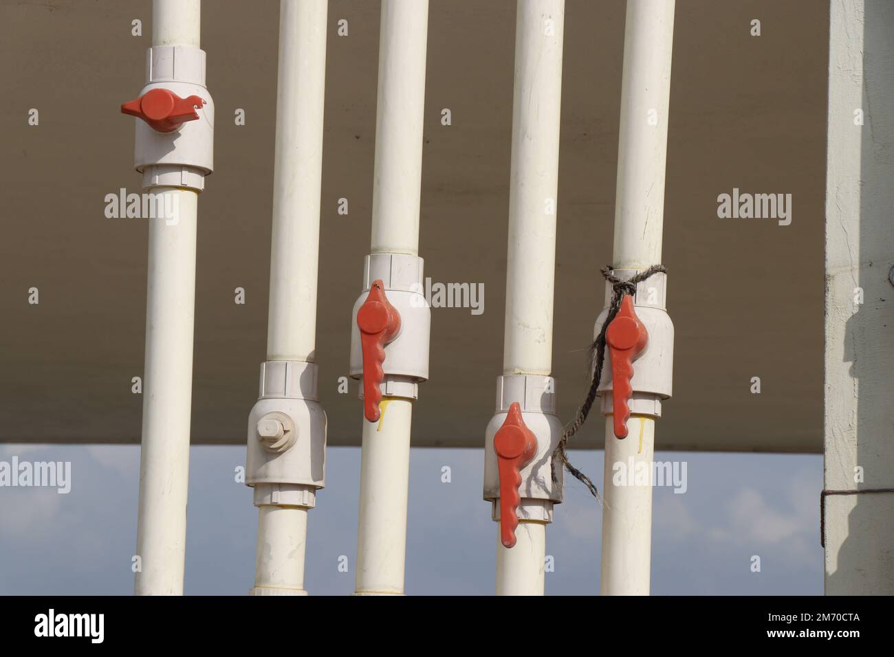 The water valve connects to a PVC pipe on the rooftop of a building for ...