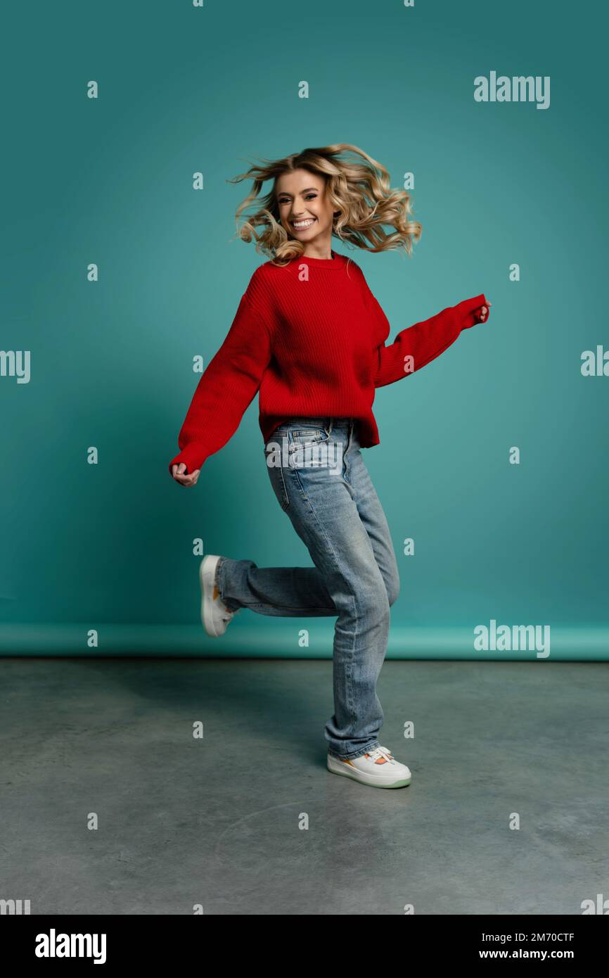 Having Fun. Full body length portrait of happy young blonde woman ...