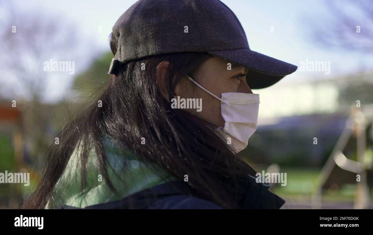 Woman wearing covid face mask outside Stock Photo - Alamy
