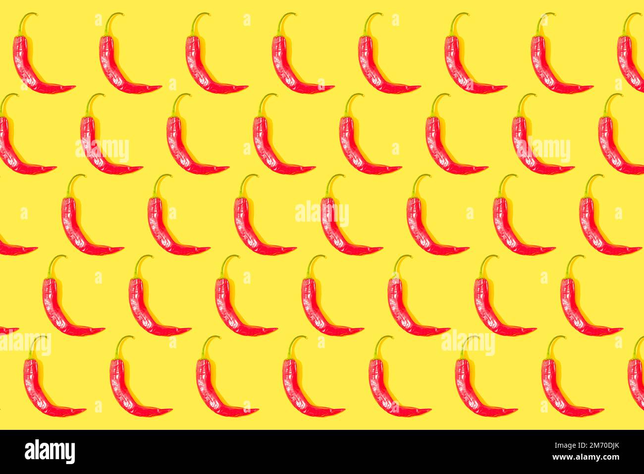 Chilli peppers pattern on yellow background Stock Photo - Alamy