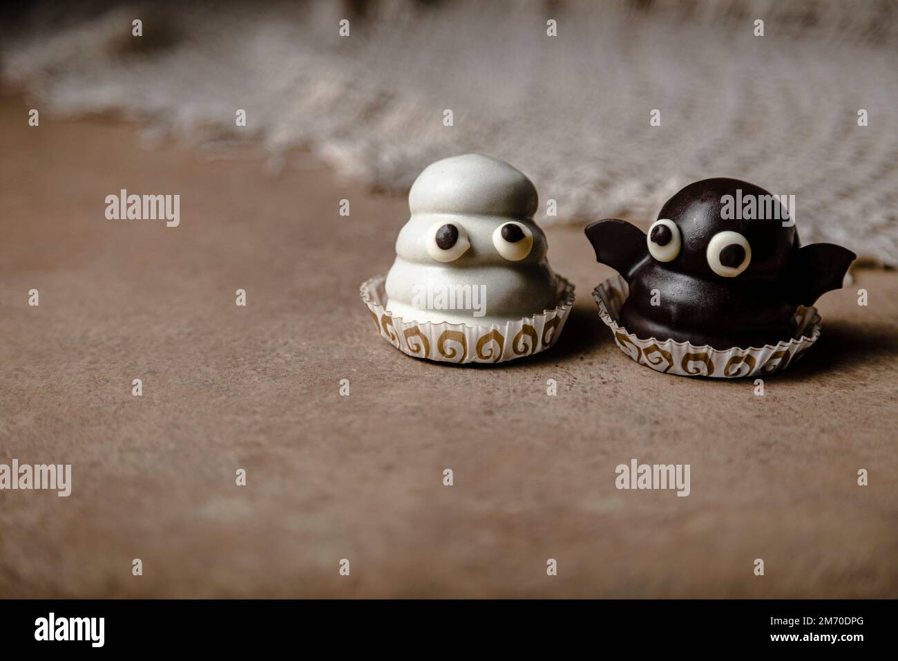 Ghost and bat sweets over table for Halloween; made with cookie base ...