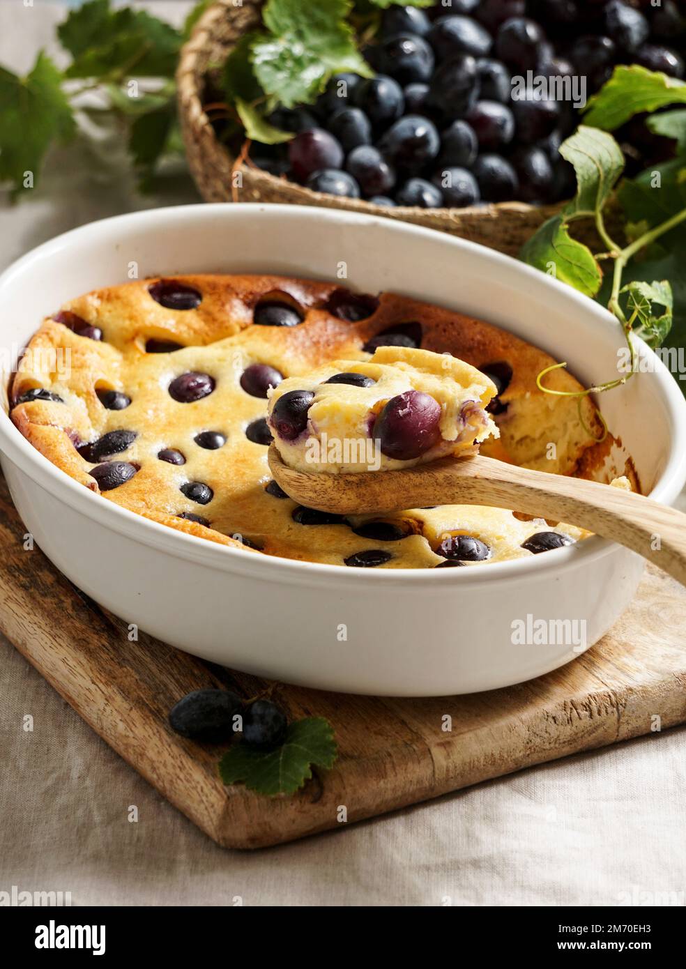 red grape clafoutis, French cuisine. on a table made of ceramic tiles ...