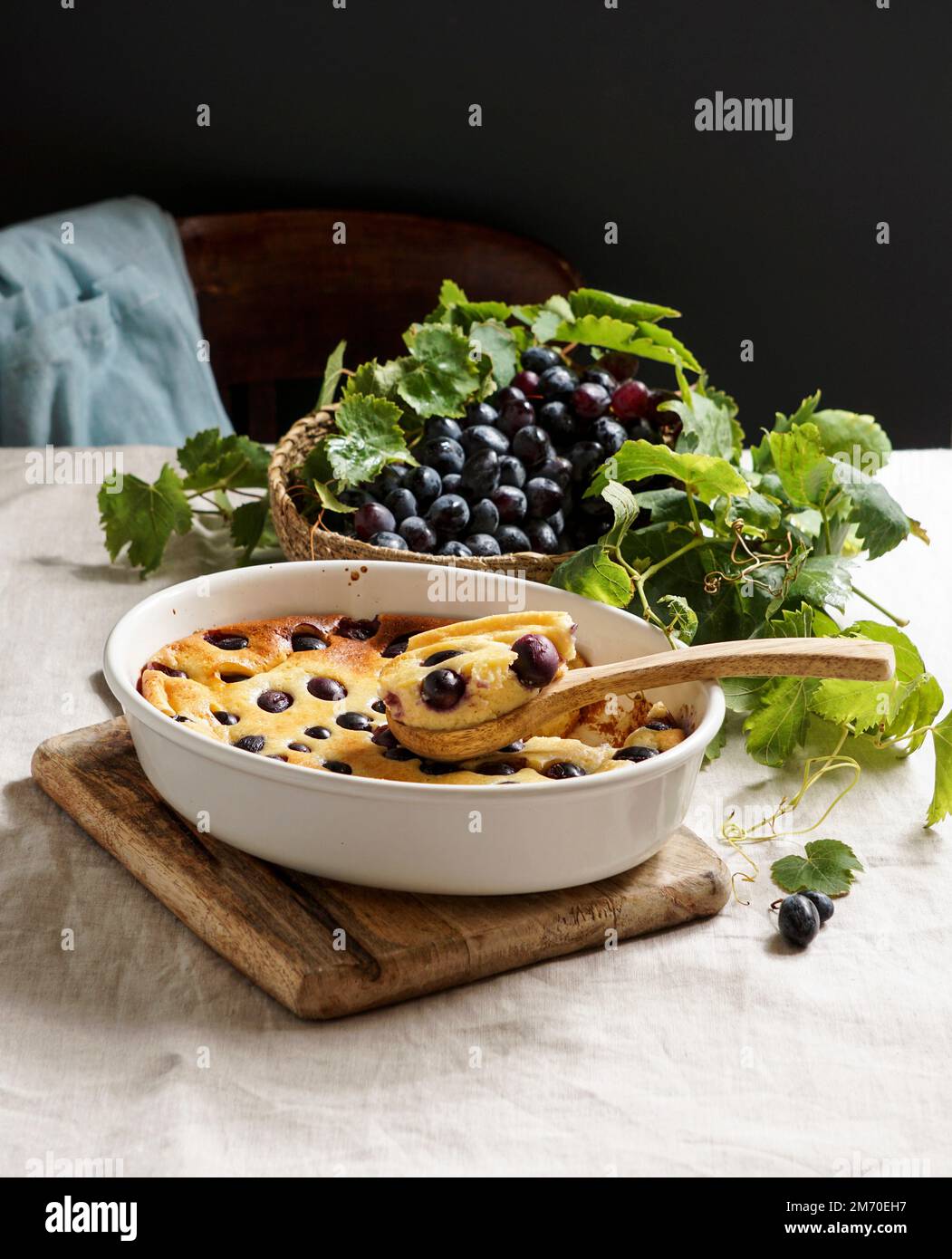 red grape clafoutis, French cuisine. on a table made of ceramic tiles ...