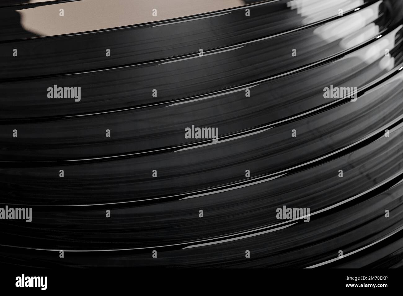 An image of shiny dark grey round objects with layers with a light ...