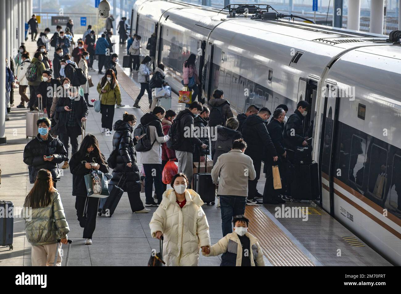 Passengers line up to enter the bullet train at the high speed rail ...