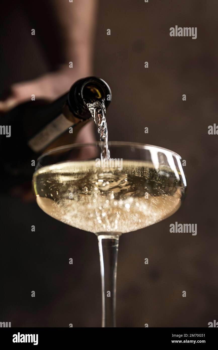 Prosecco pour into coupe glass Stock Photo - Alamy