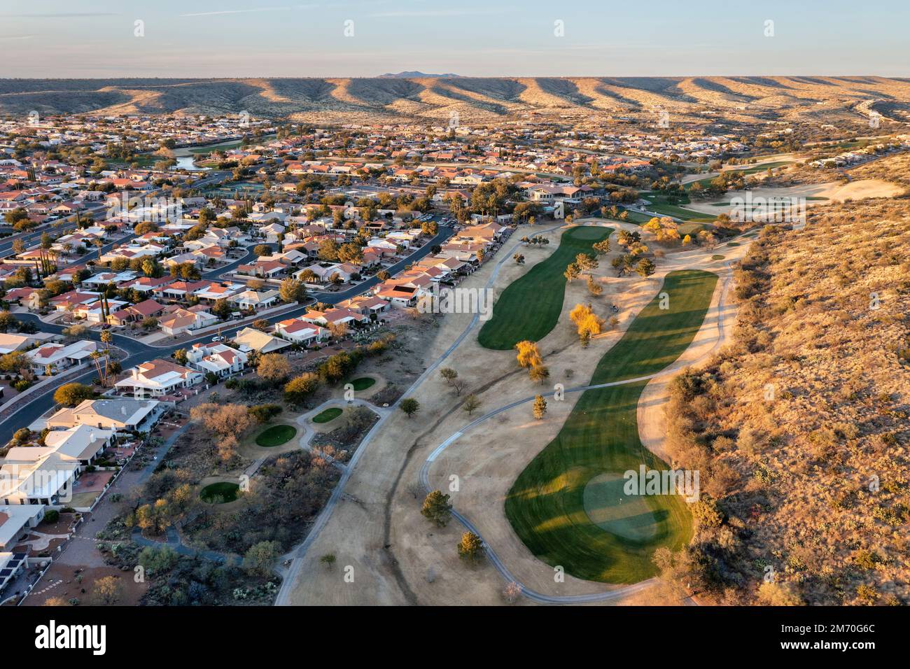 Aerial view of a suburban residential community with a golf course in a ...
