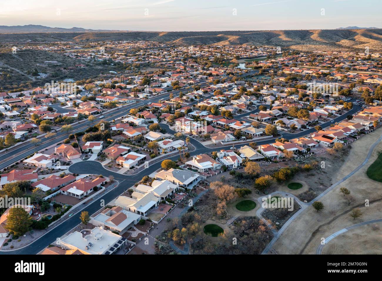 Aerial view of a suburban residential community with a golf course in a ...