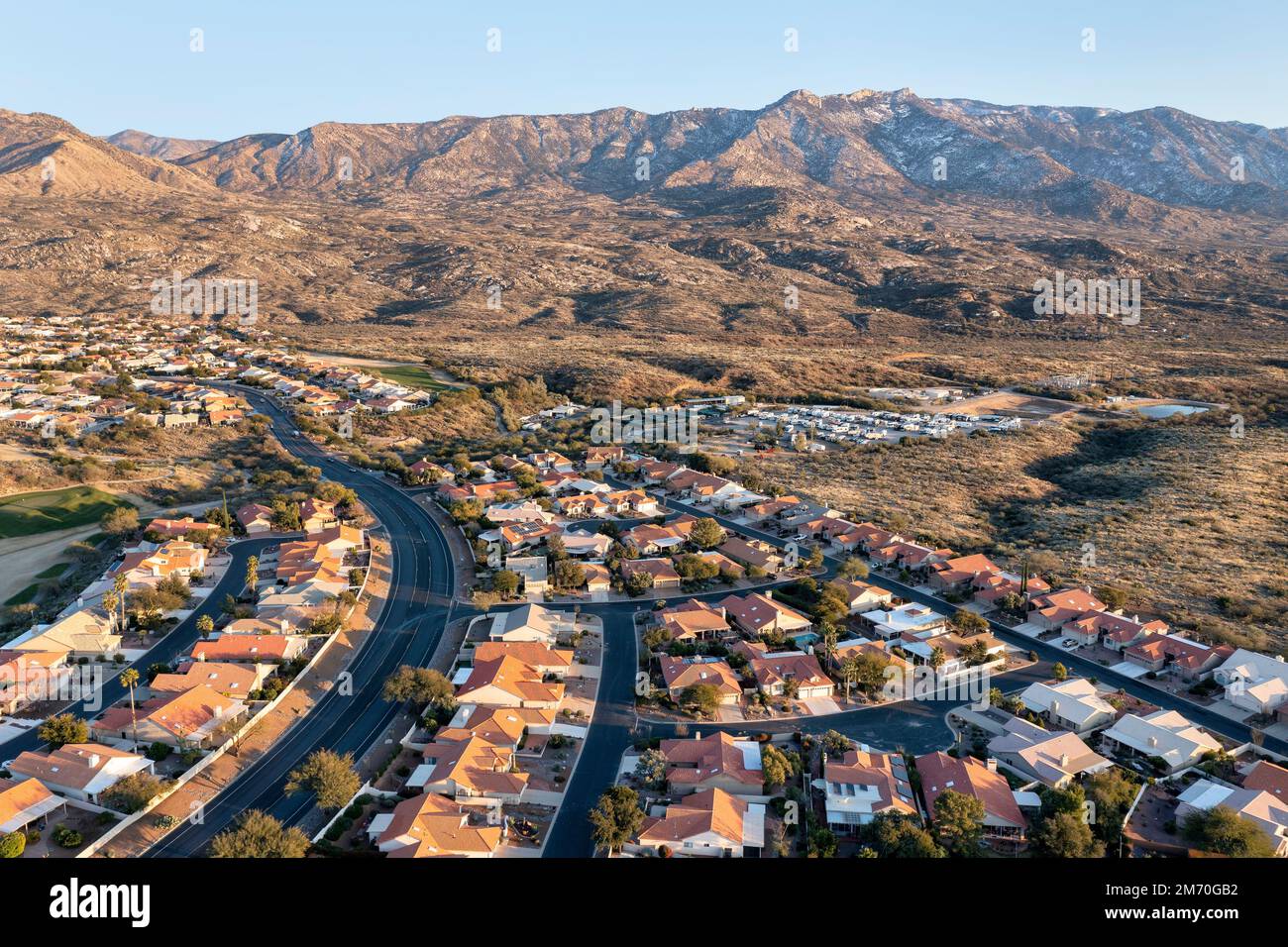 Aerial view of a suburban residential community with a golf course in a ...