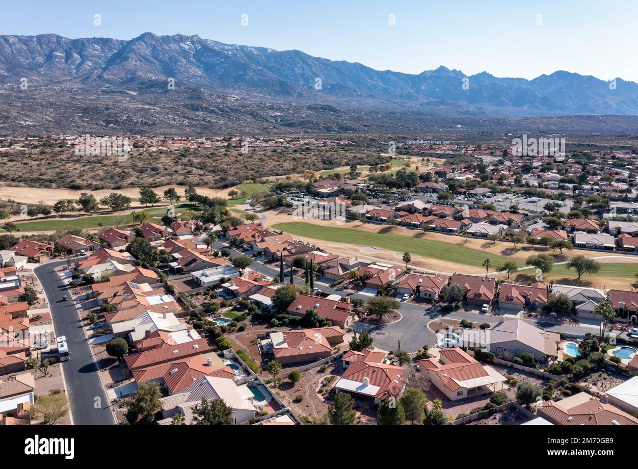 Aerial view of a suburban residential community with a golf course in a ...